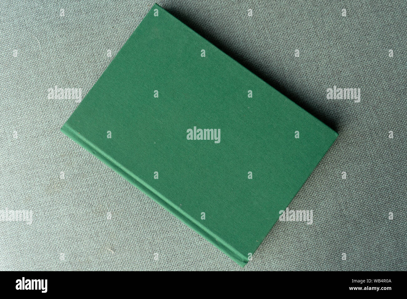 Green blank book on the fabric. Book texture, background Stock Photo ...