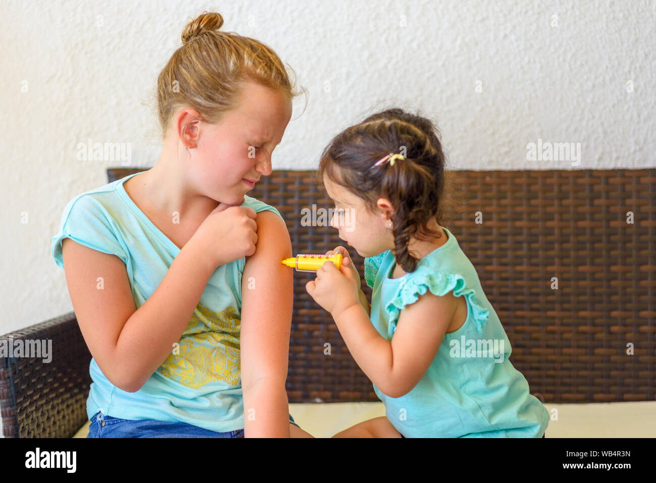 Children playing doctor. Doctor injecting vaccination Flu Shot in arm ...