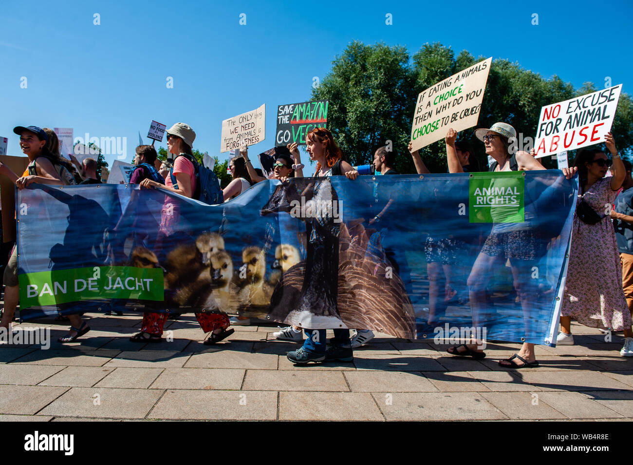 A group of animals activists hold a large banner and placards during ...