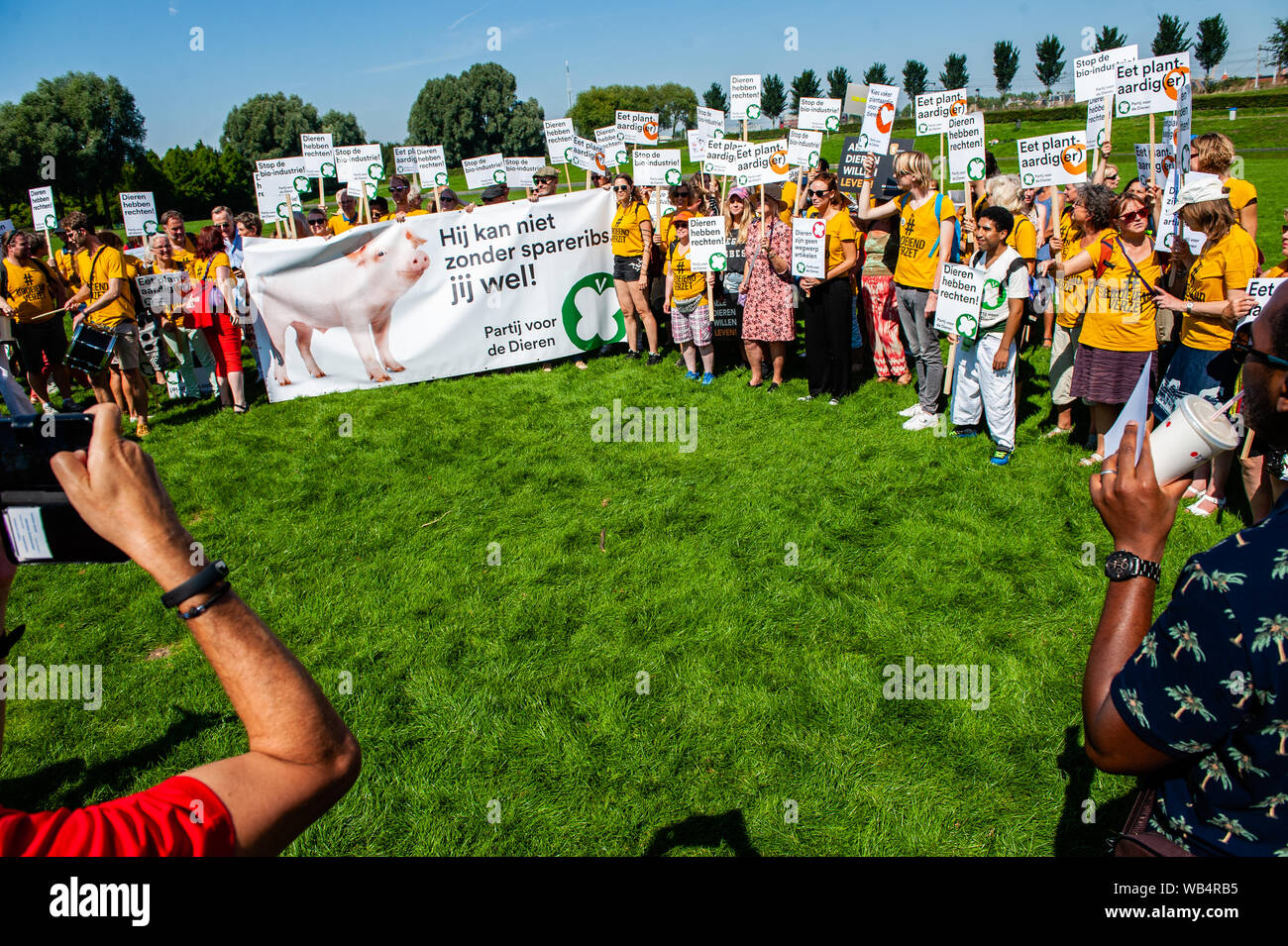 A group of protesters hold a banner and placards during the ...