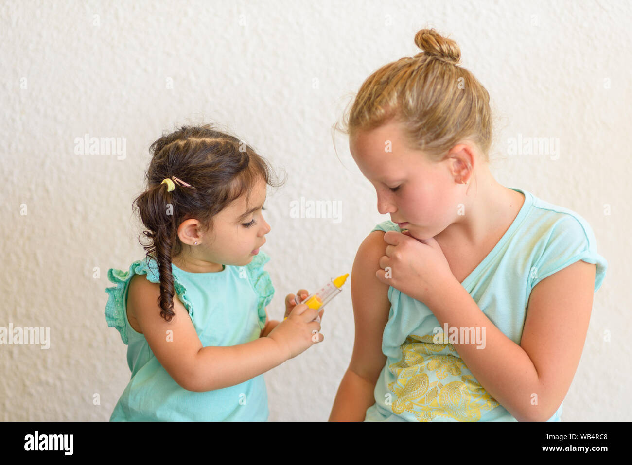 Children playing doctor. Doctor injecting vaccination Flu Shot in arm ...