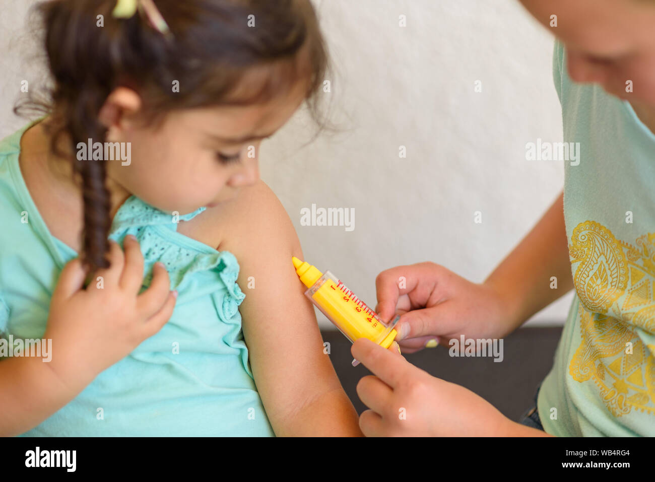 Children playing doctor. Doctor injecting vaccination Flu Shot in arm ...