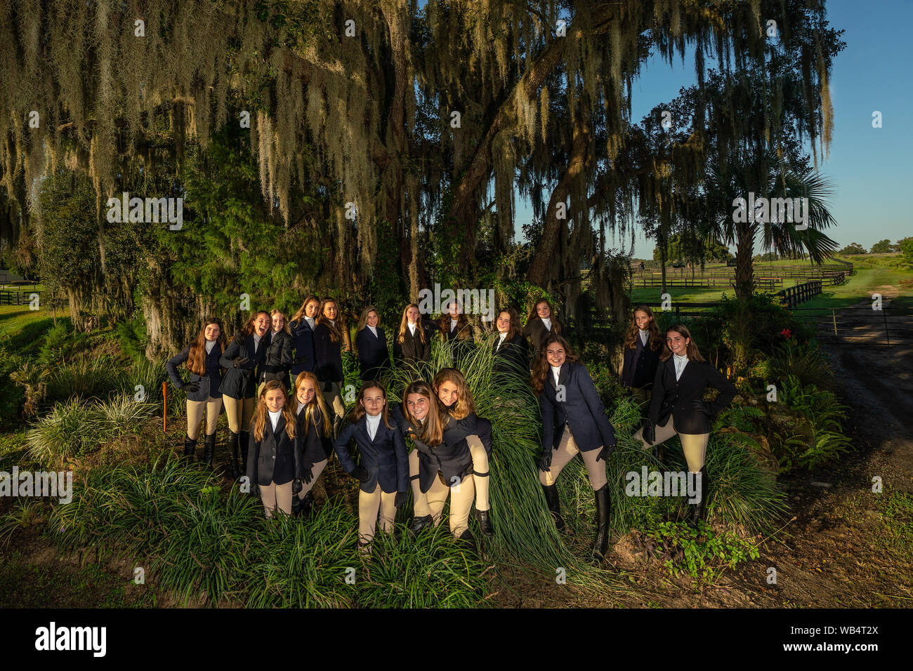 A group of young female english riders in uniform are posing for the ...
