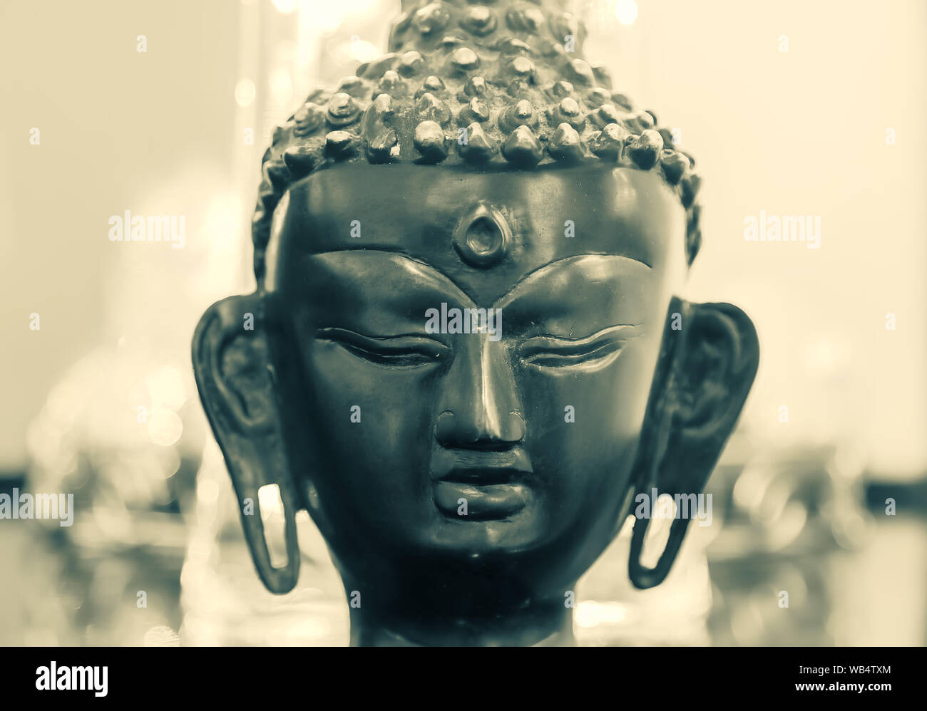 Bronze statue of Buddha, in split tone Stock Photo - Alamy