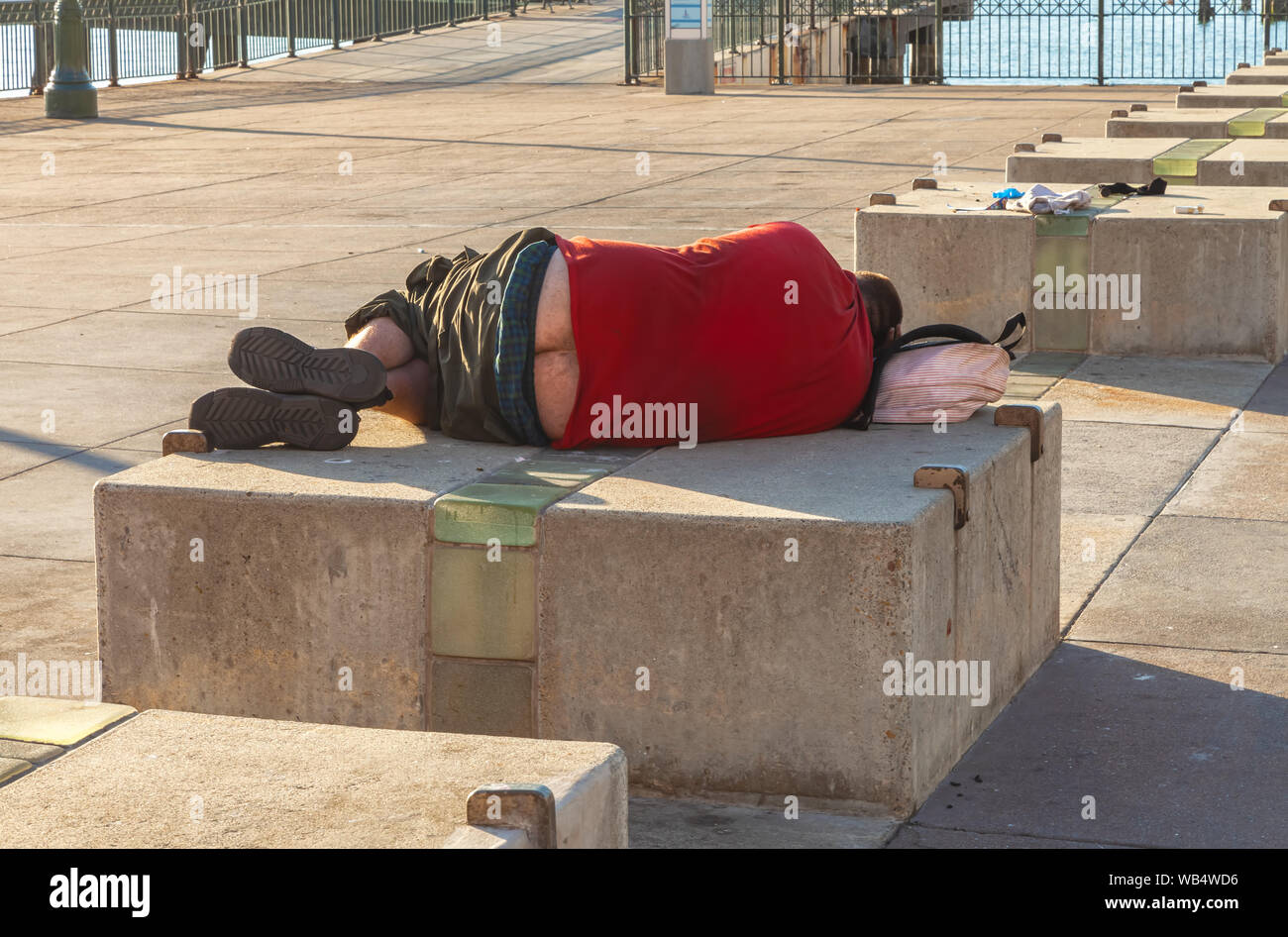 A homeless man sleep by the San Francisco Pier 14, California, USA ...