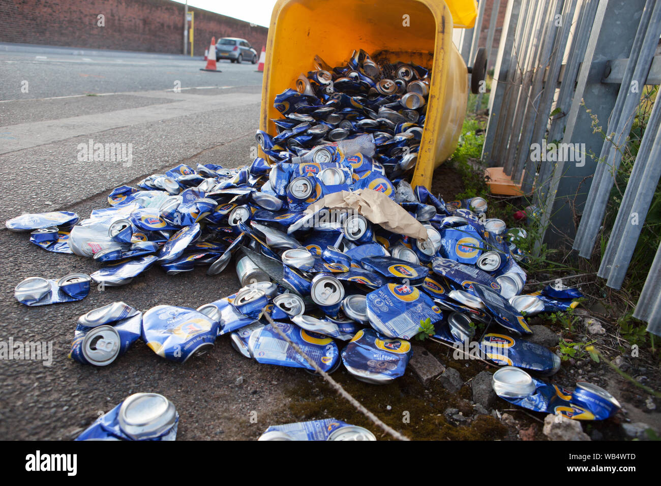 Yellow recycle box with hundreds of beer cans scattered on the street ...