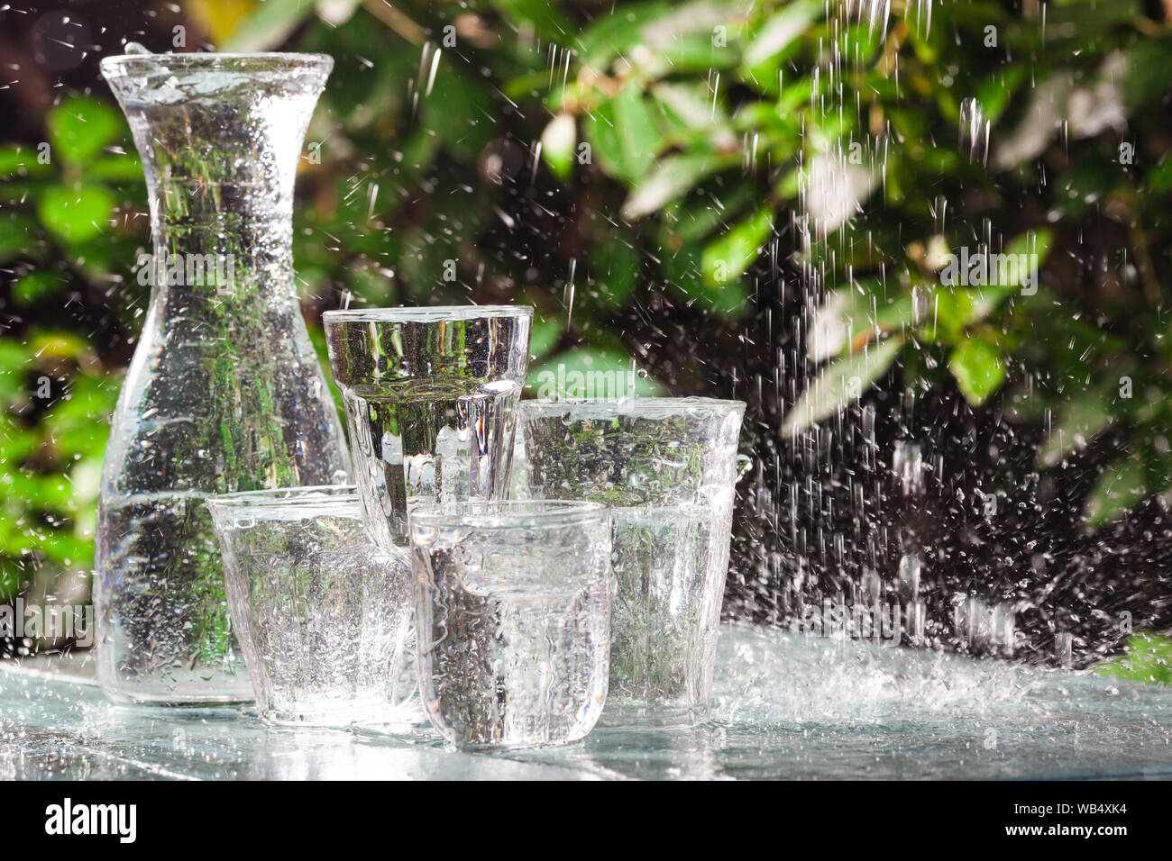 Glasses full of water for the refreshment on a hot summer day. Rain ...