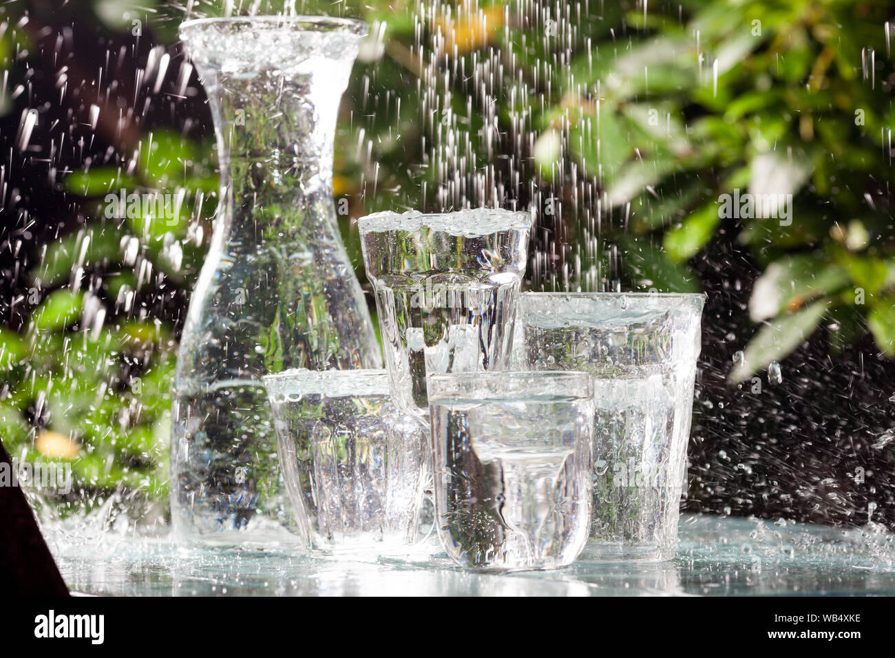 Glasses full of water for the refreshment on a hot summer day. Rain ...