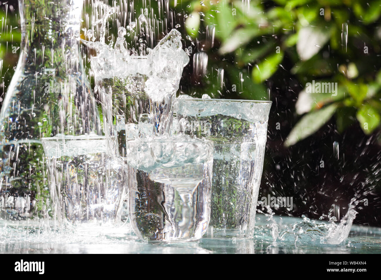 Glasses full of water for the refreshment on a hot summer day. Rain ...