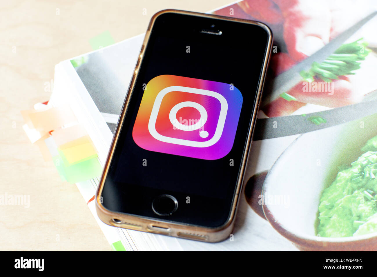 Hand holding a smartphone with an Instagram icon on screen. IPhone with ...