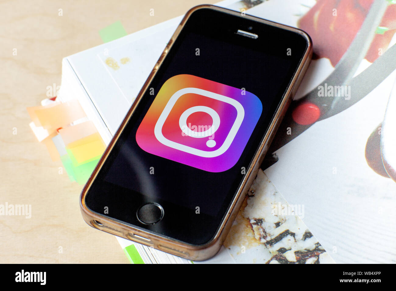 Hand holding a smartphone with an Instagram icon on screen. IPhone with ...