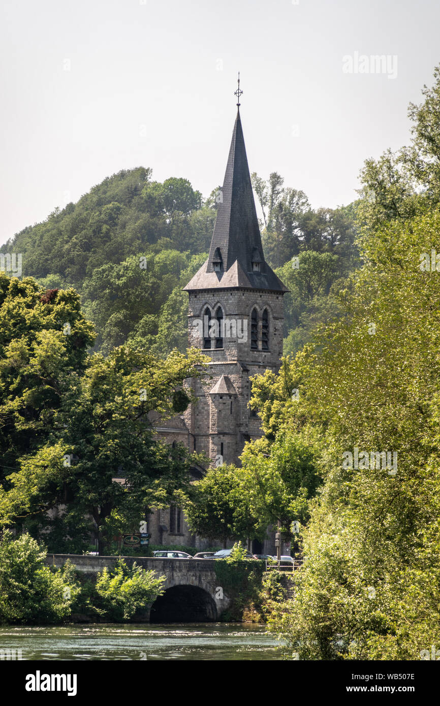 Dinant, Belgium - June 26, 2019: Gray stone tower and spire of Saint ...
