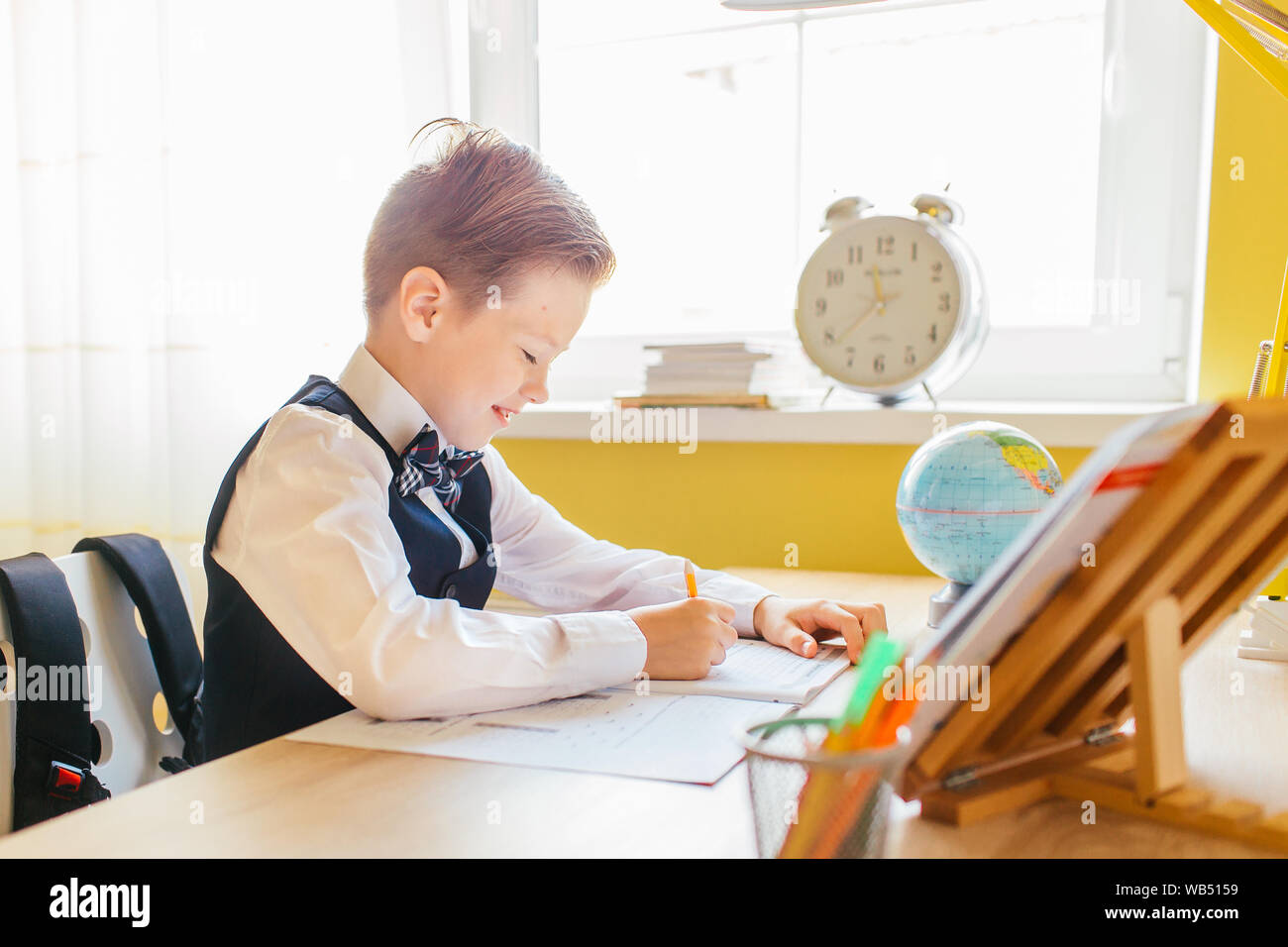 Education at home concept - Cute little boy studying or completing home ...