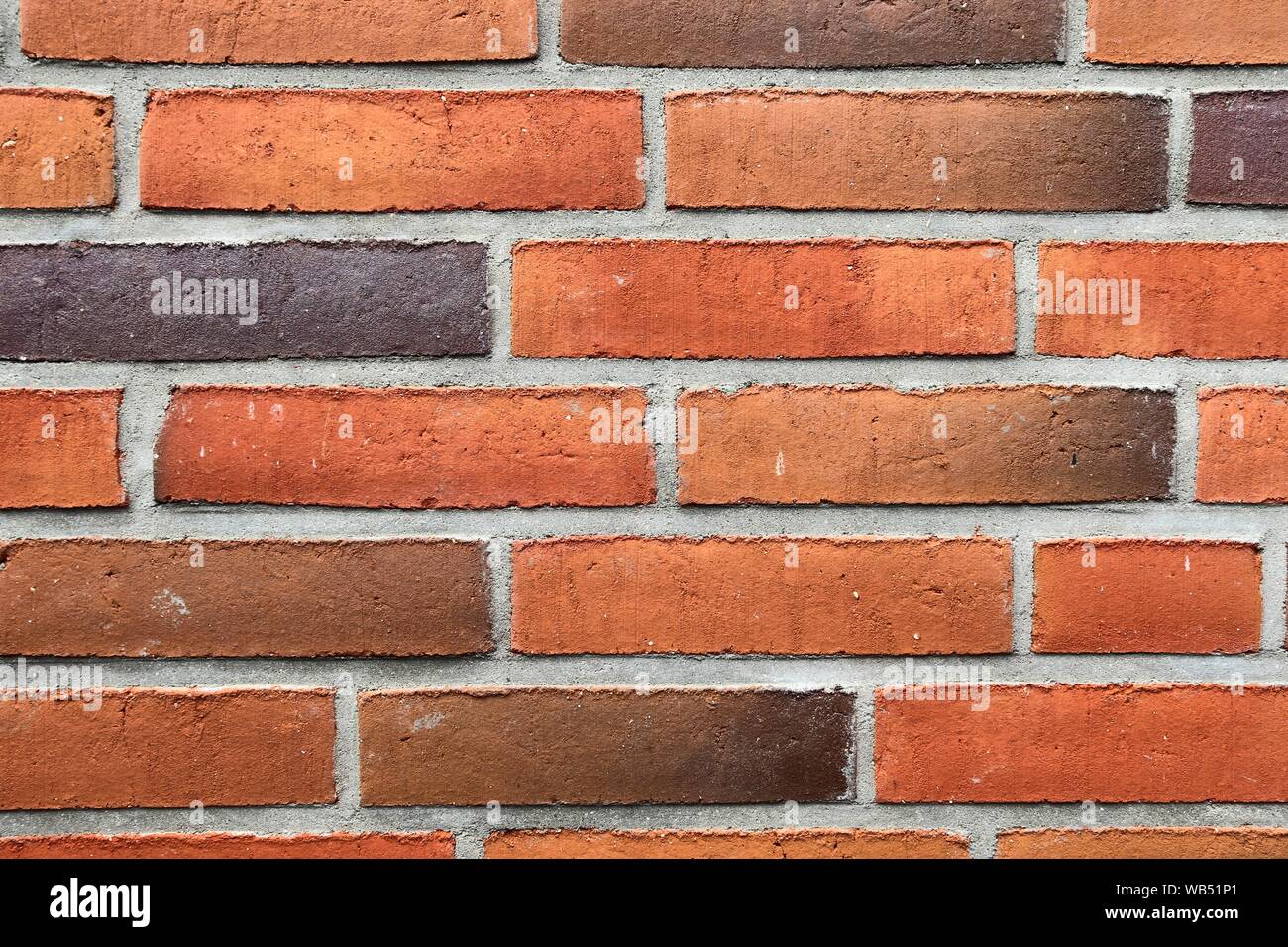 Detailed close up view on an aged and weathered red brick wall texture ...
