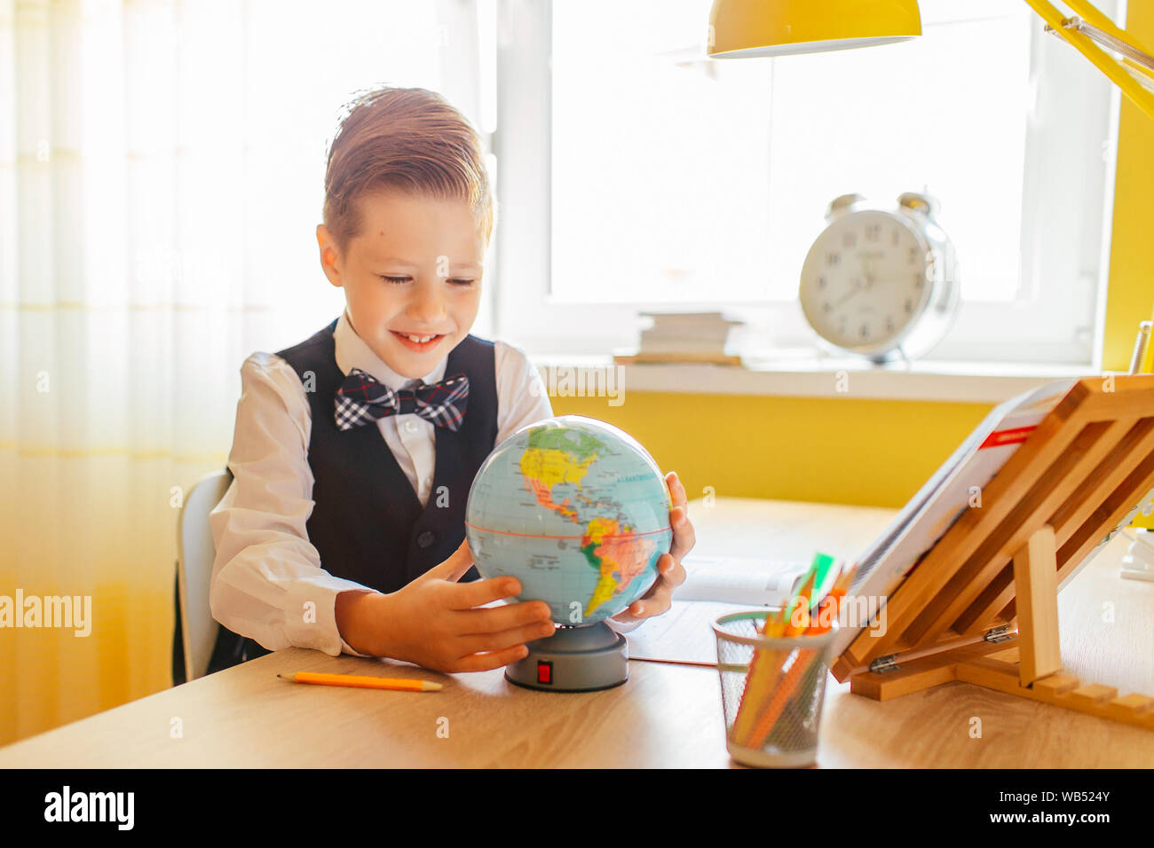 Education at home concept - Cute little boy studying or completing home ...