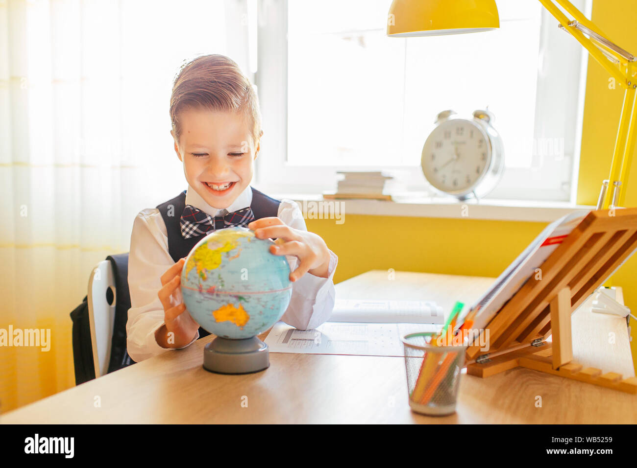 Education at home concept - Cute little boy studying or completing home ...