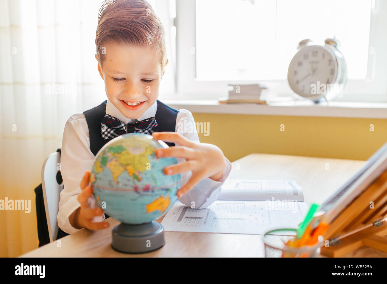 Education at home concept - Cute little boy studying or completing home ...