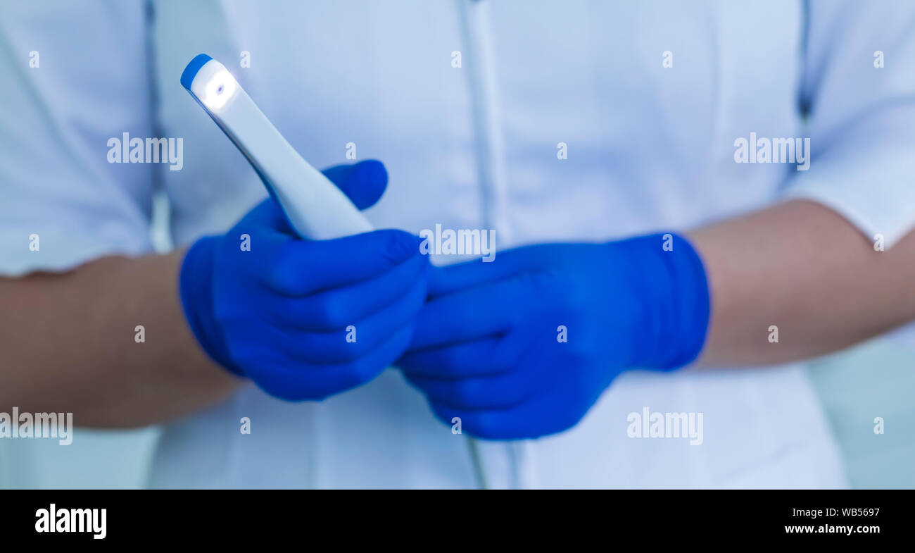 Tooth examination with intraoral cameras. Intra Oral camera handed by ...
