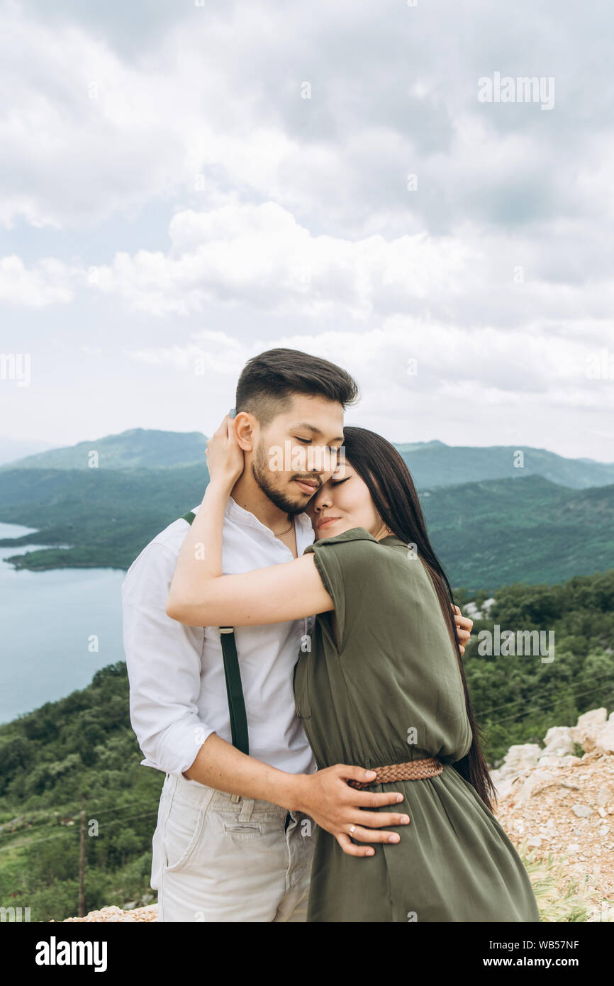 Portrait of a young beautiful couple. She laid her head on his chest ...