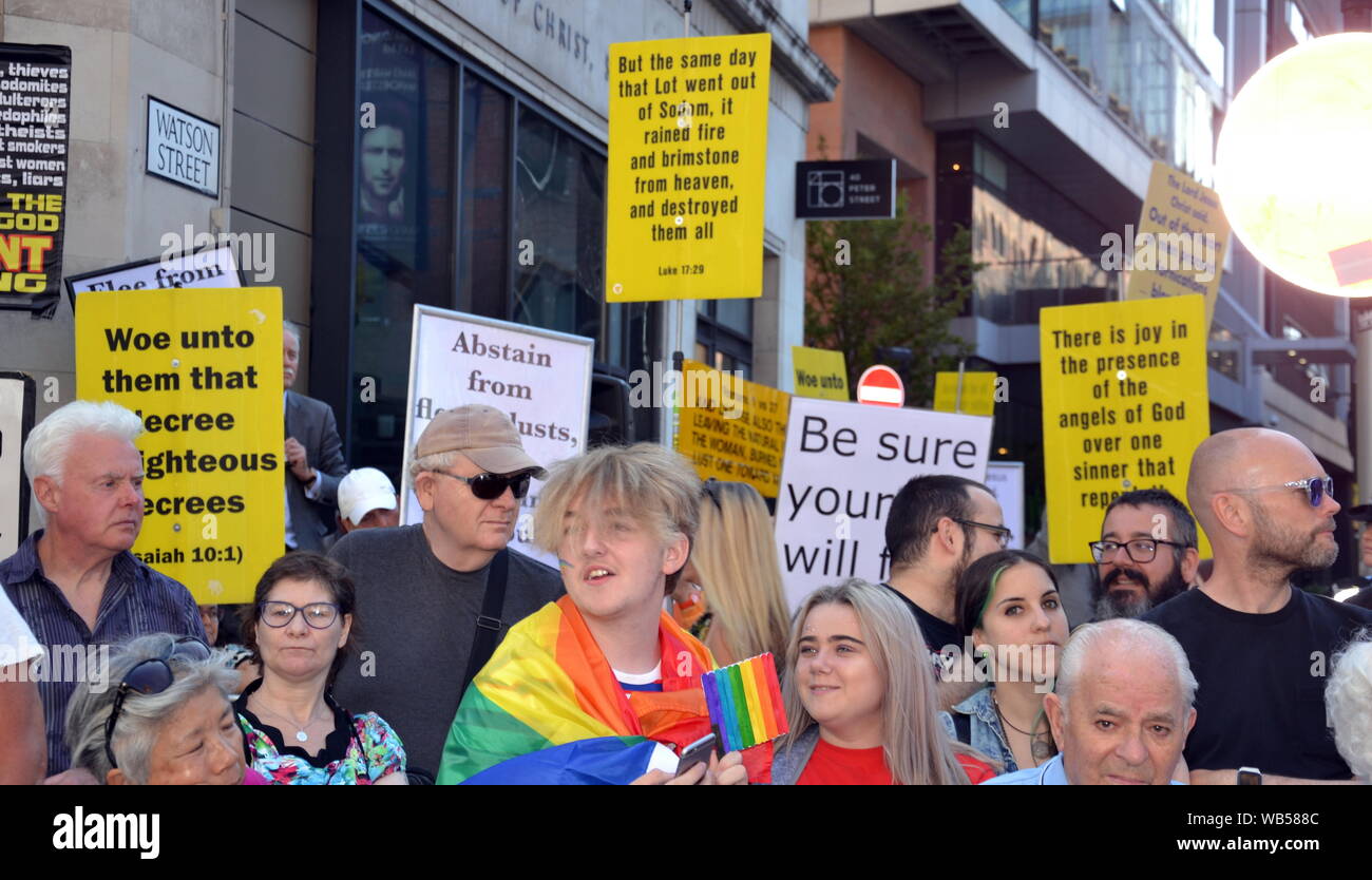 Christians with placards protest on the pavement as the Manchester, uk ...