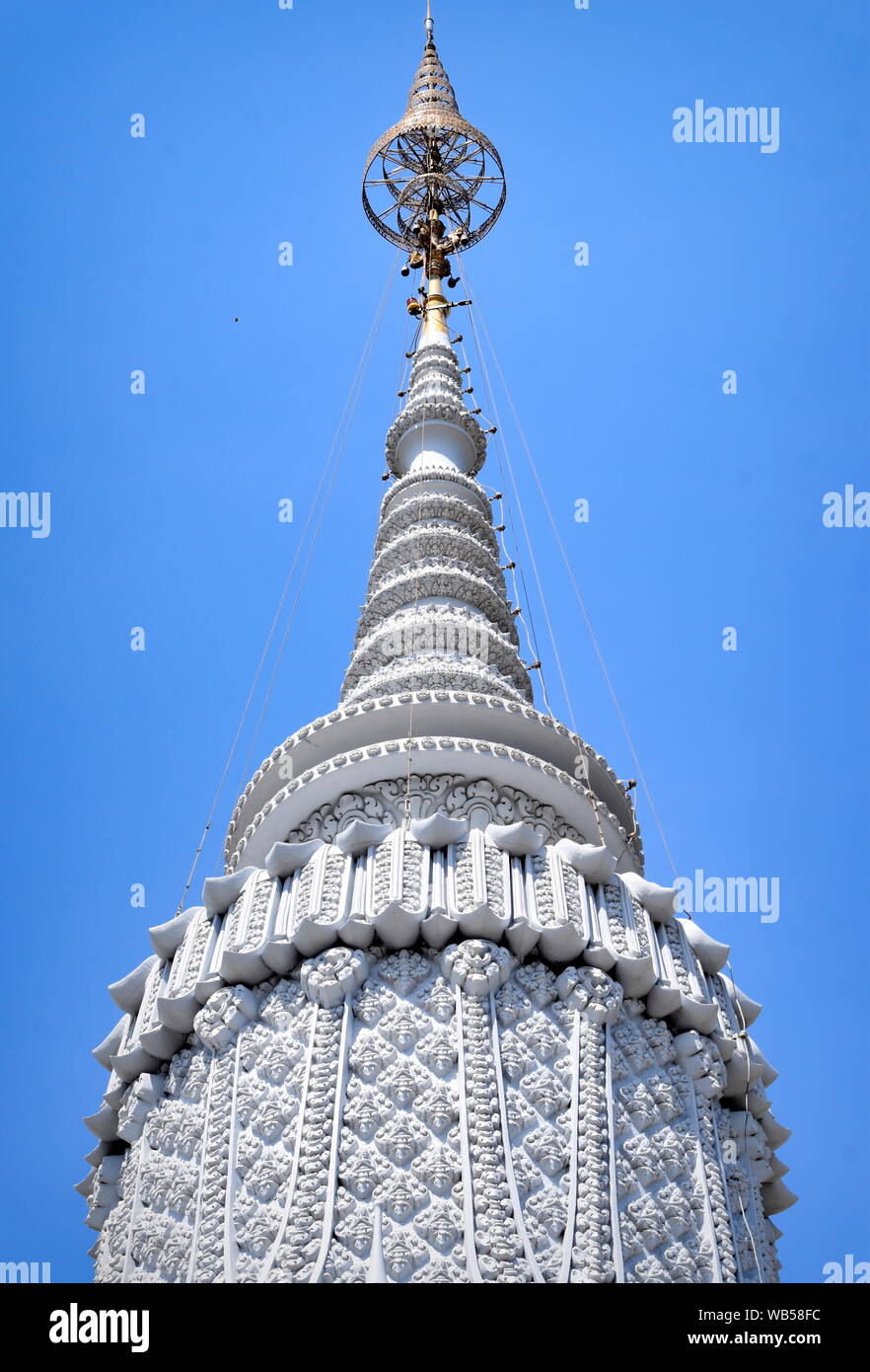 Top spire of landmark Oudong white stupa housing Buddha relics ...
