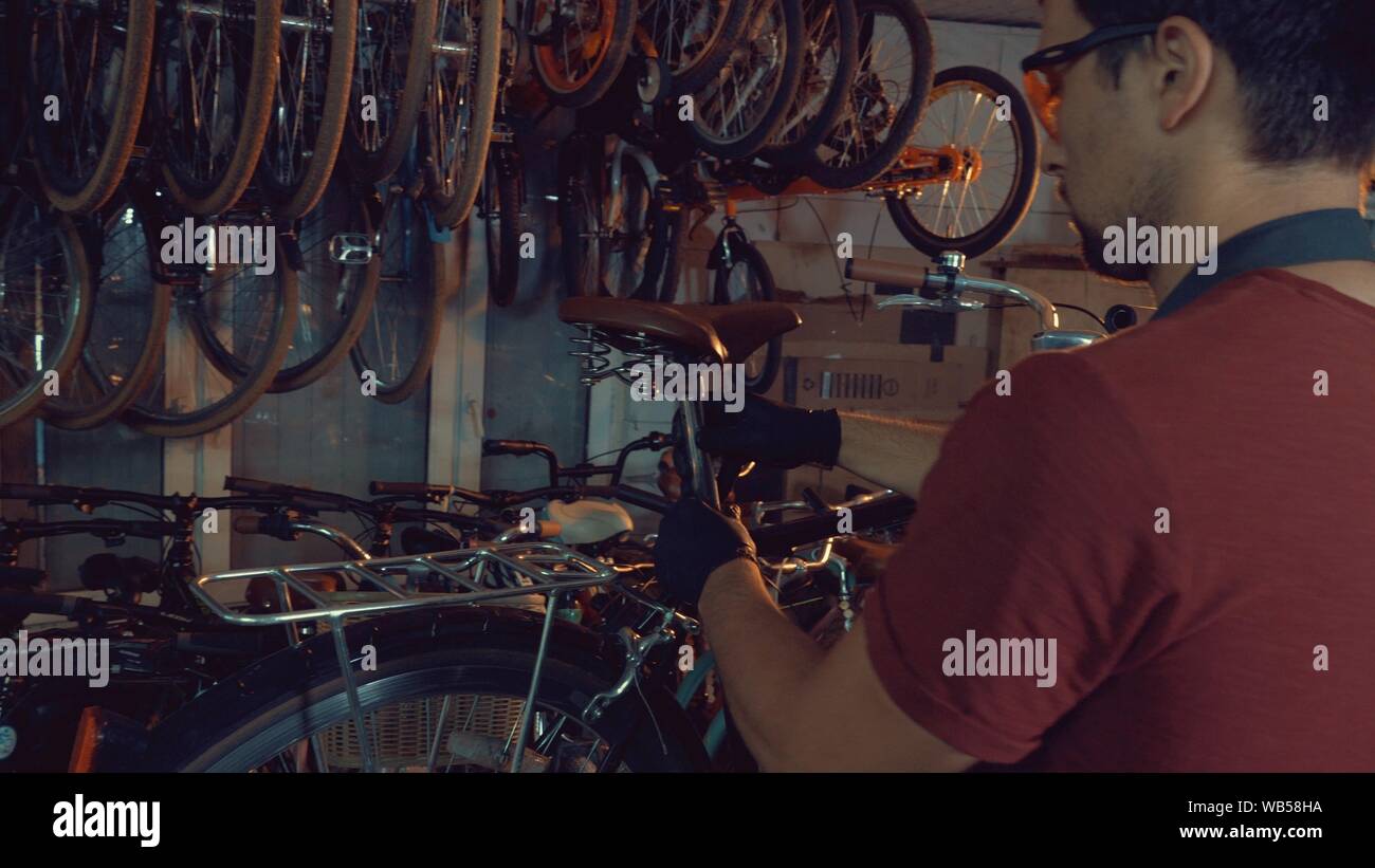 theme small business bike repair. A young Caucasian brunette man ...