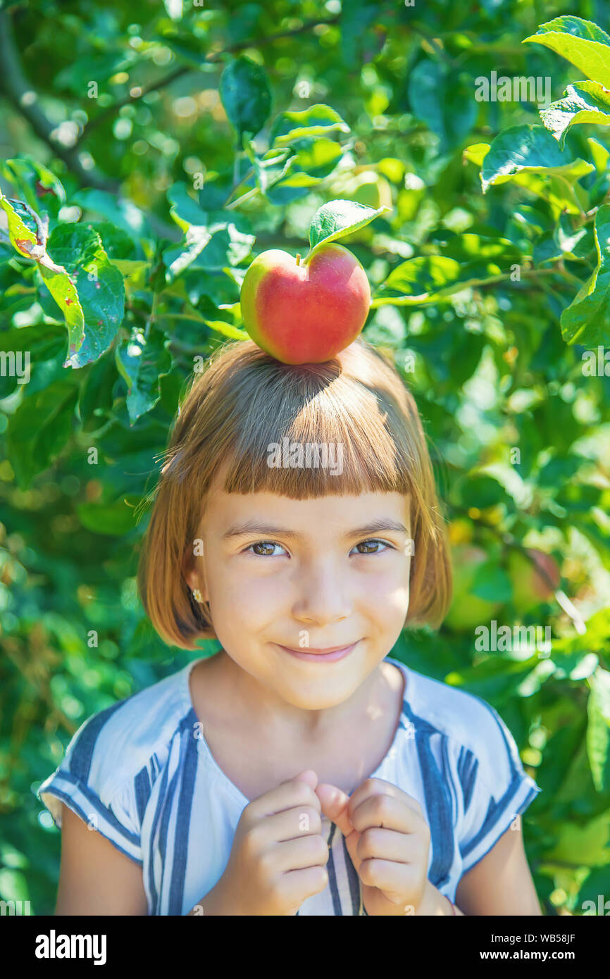 child with an apple in the garden. Selective focus Stock Photo - Alamy