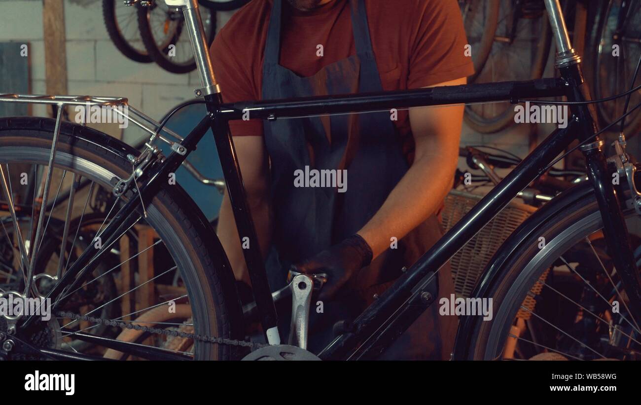 theme small business bike repair. young Caucasian brunette man wearing ...