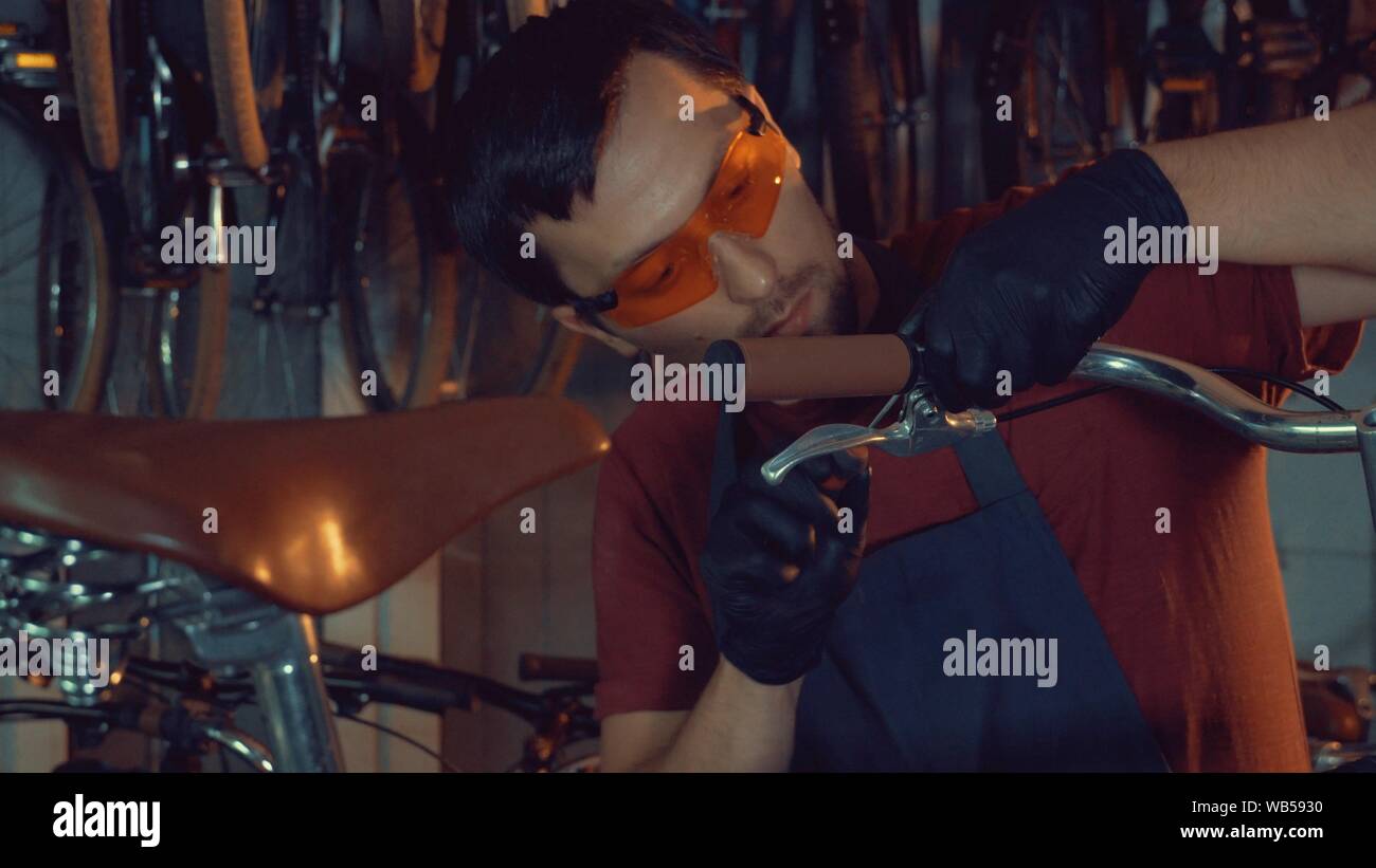theme small business bike repair. A young Caucasian brunette man ...