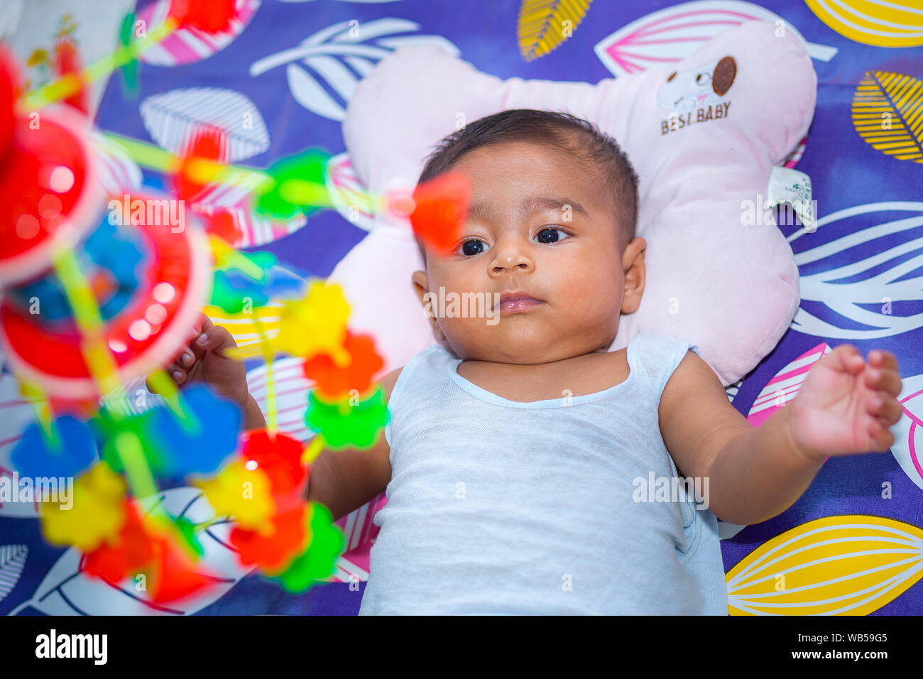 The child is looking at colorful toys Stock Photo - Alamy