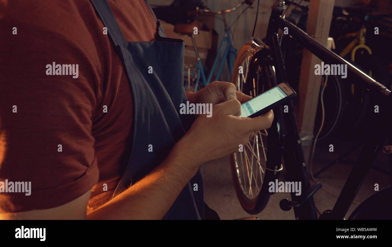 theme small business bike repair. Young caucasian brunette man wearing ...