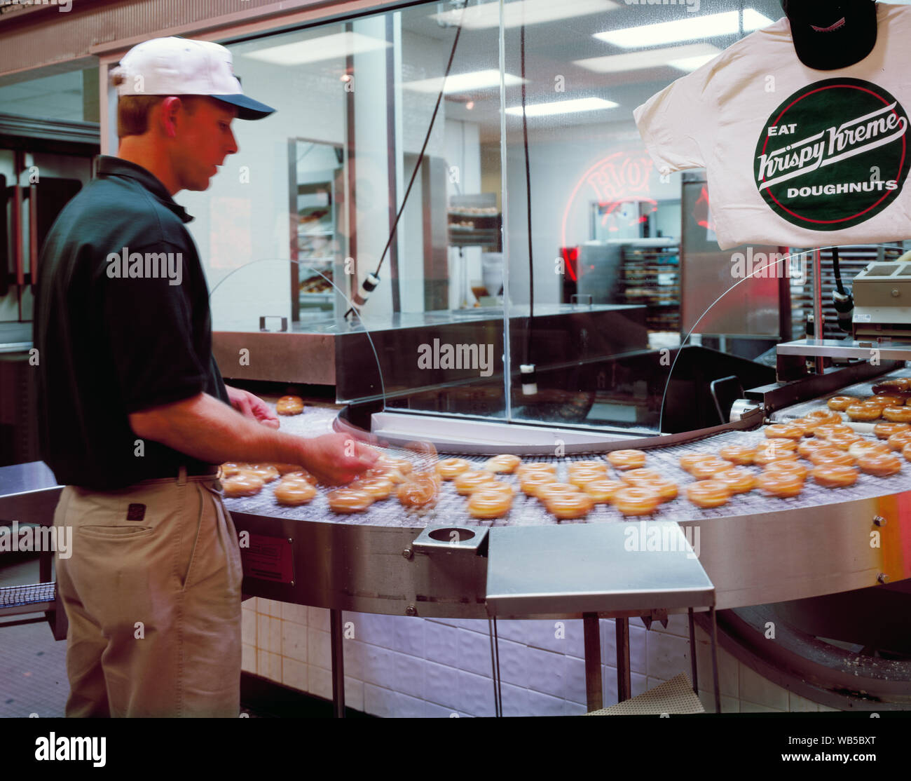 Employee watches the production line at the nation's first Krispy Kreme ...