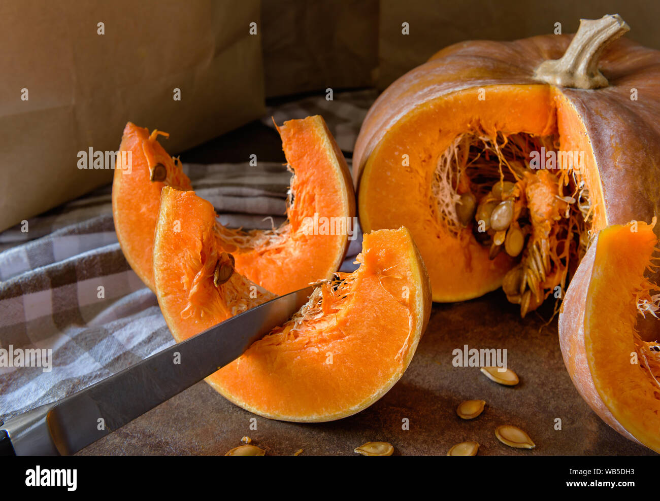 Still life with pumpkin. There is a sliced pumpkin, two slices of ...