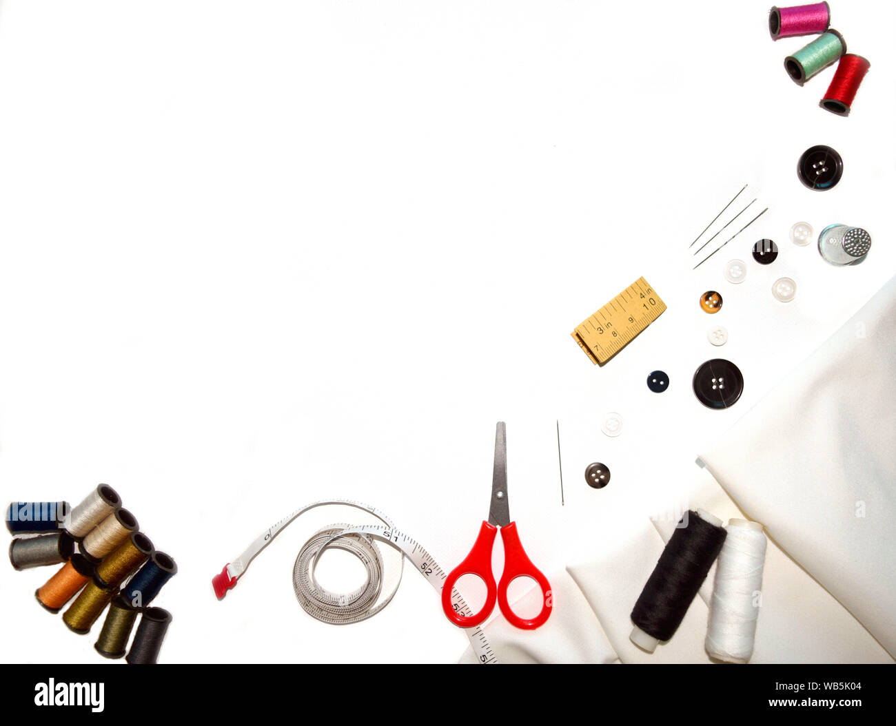 Copy-space frame with sewing tools and fabric on white background Stock ...