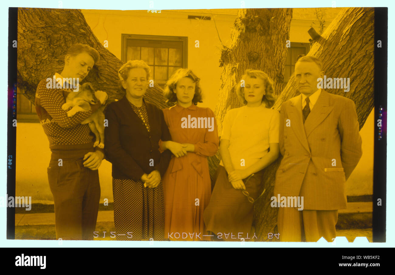 Eric and Edith Matson standing in front of tree with their children ...