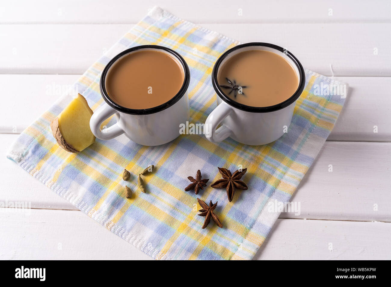 Indian traditional Masala chai tea in aluminum mugs, anise and badian ...