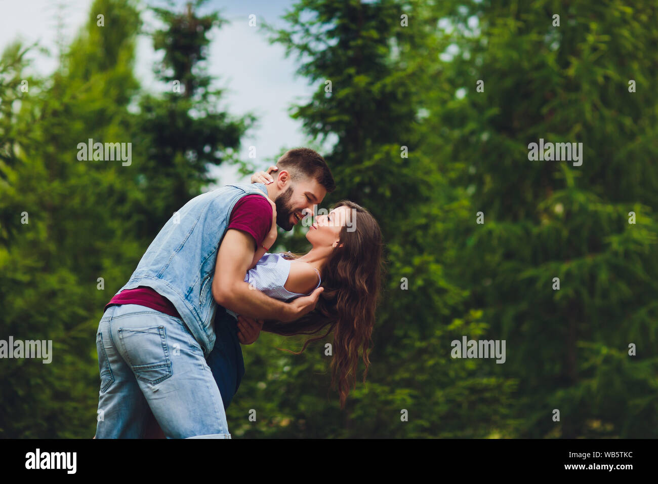 Cheerful young couple having fun and laughing together outdoors Stock Photo - Alamy