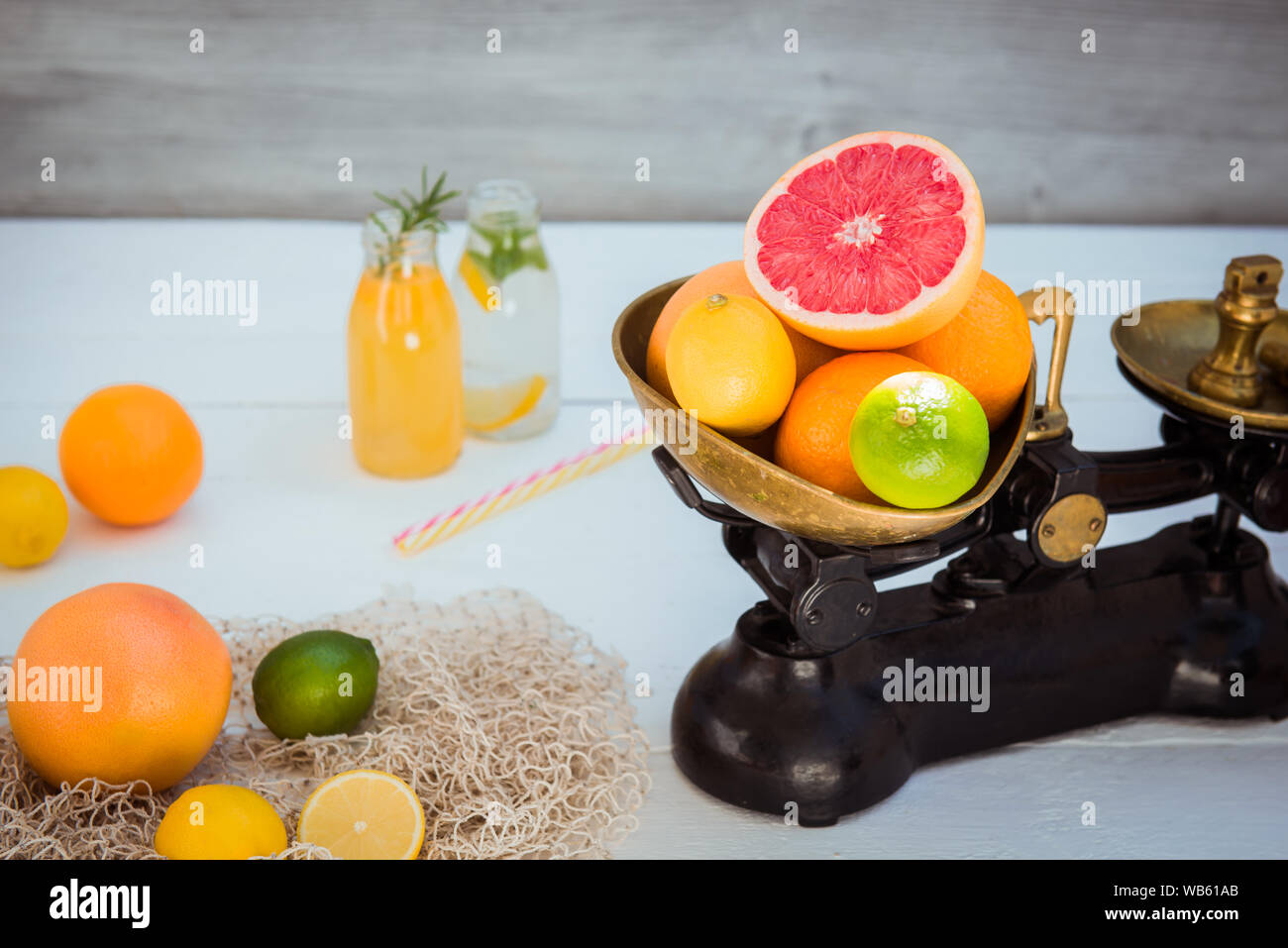 Fresh citrus fruits in vintage scale and several oranges, lemons ...