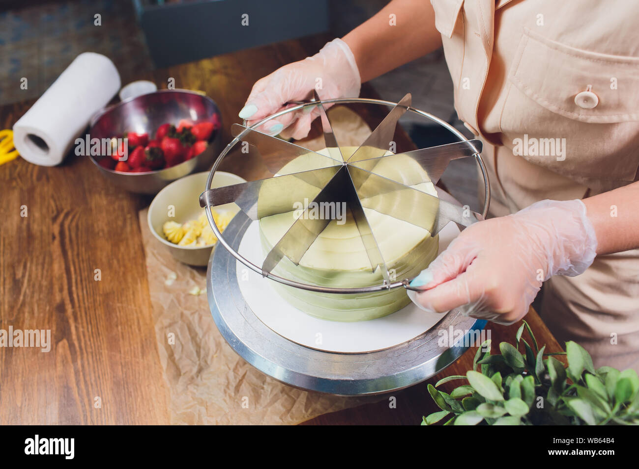 pastry chef cutting the sponge cake on layers. Cake production process ...