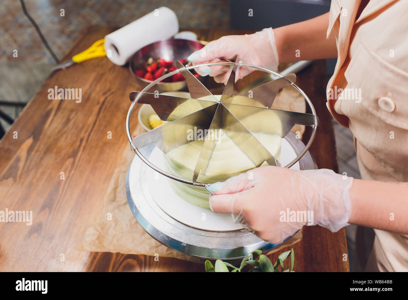 pastry chef cutting the sponge cake on layers. Cake production process ...