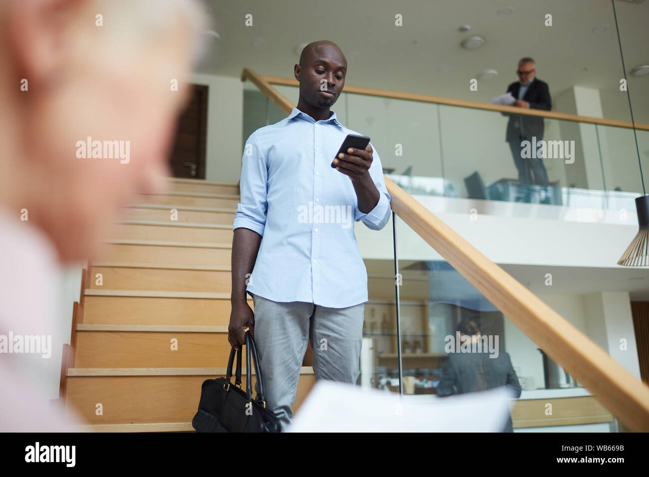 Man coming down stairs hi-res stock photography and images - Alamy