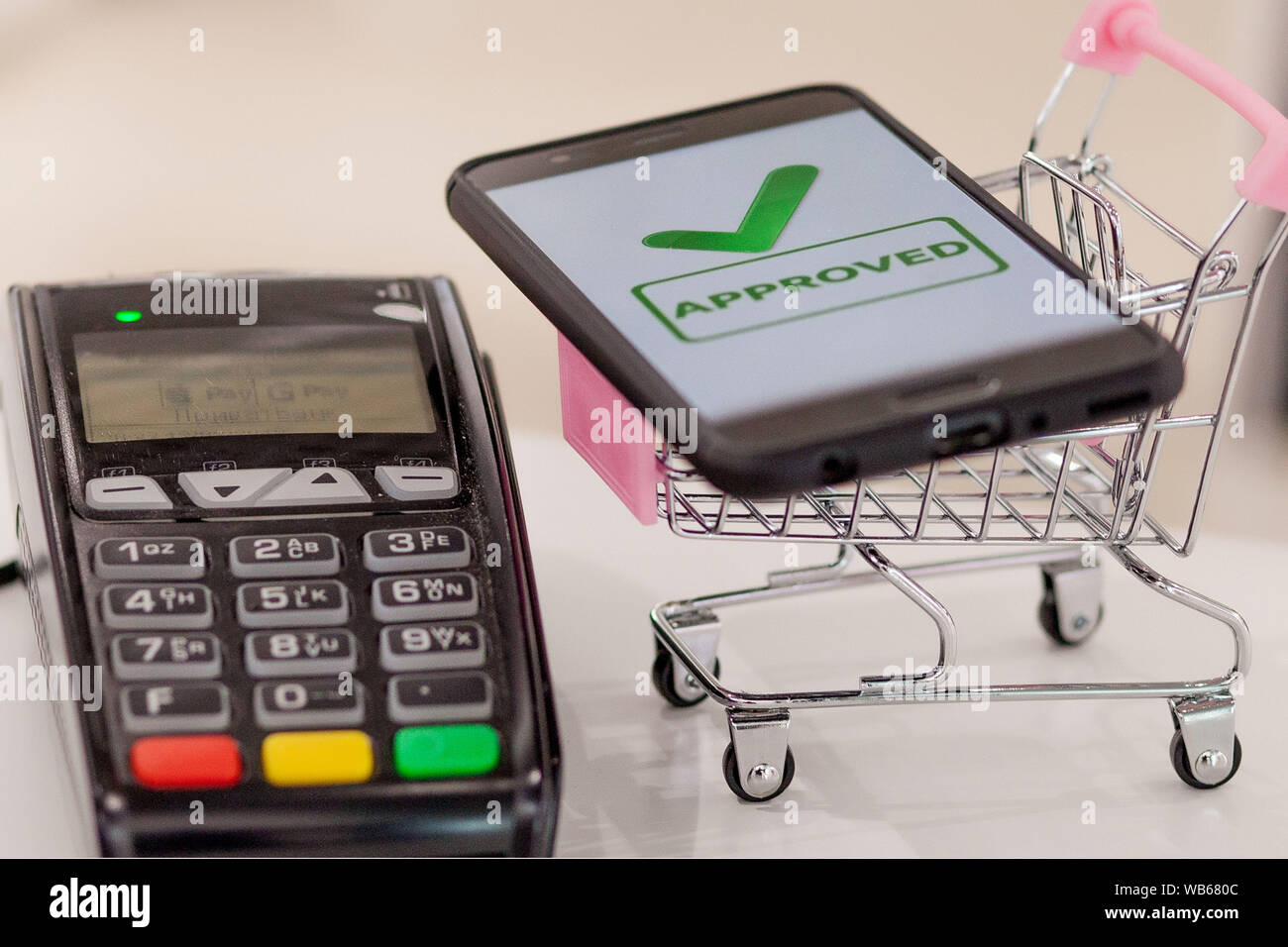 POS terminal, Payment Machine with mobile phone on store background ...