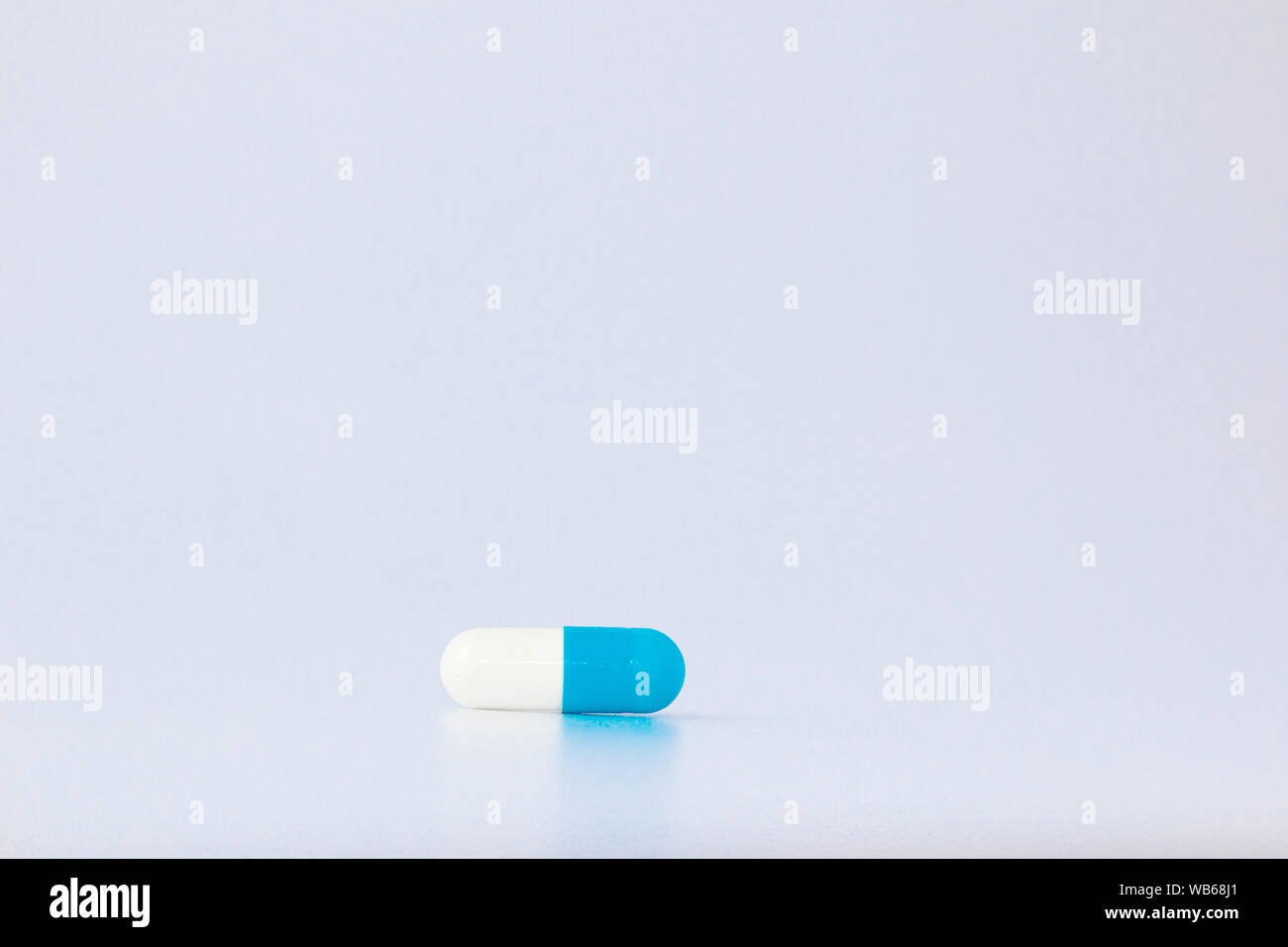 Macro view of blue capsule pill isolated over white background Stock ...