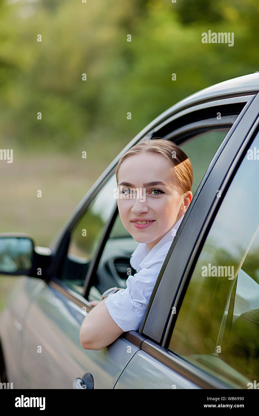 Portrait shot through windshield of pretty woman in car Stock Photo - Alamy