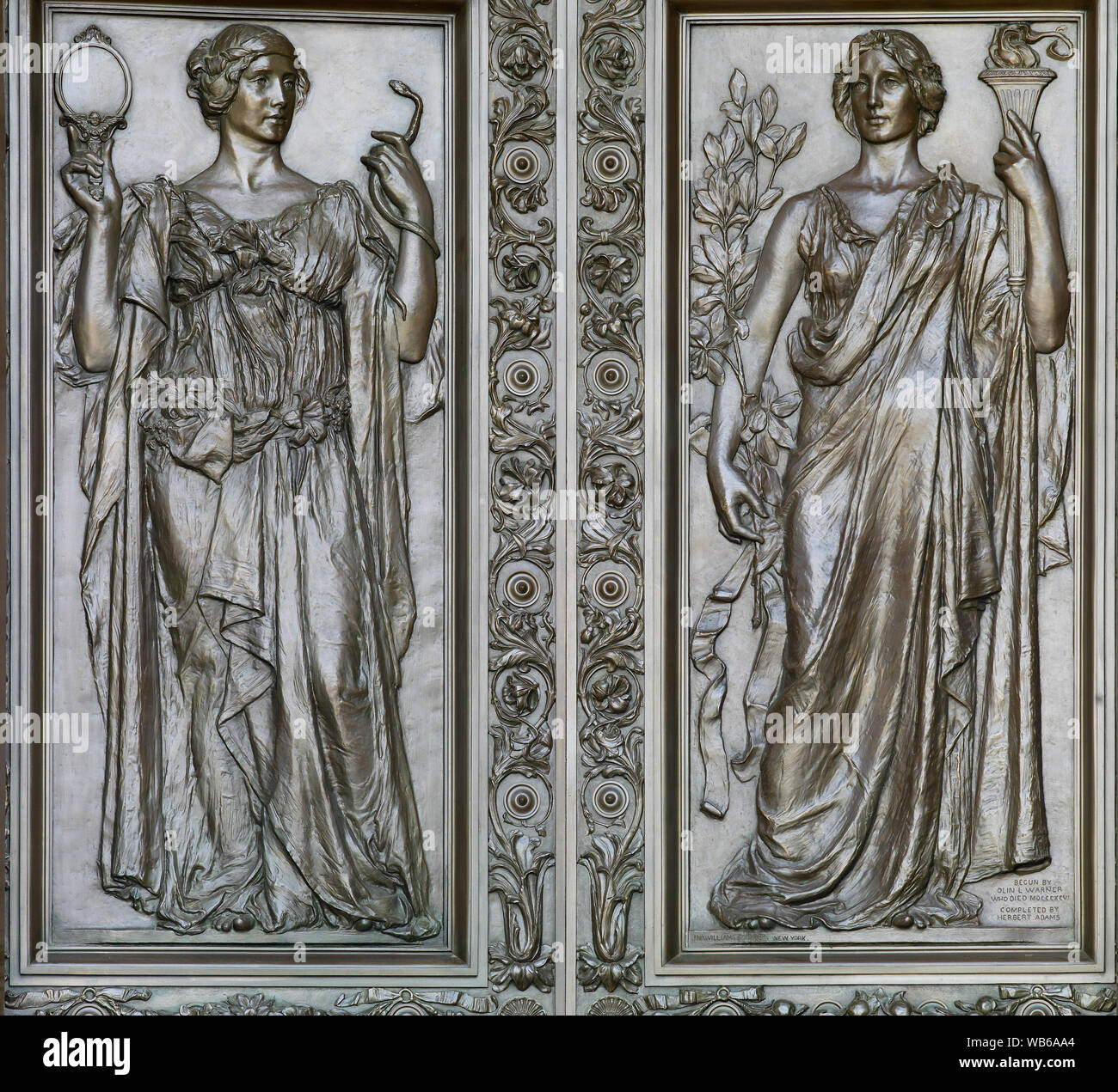 Exterior view. Bronze doors at the main entrance with female figures ...