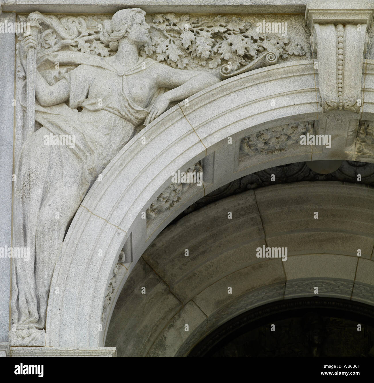 Exterior view, entrance porch. Granite sculpture with female figure ...