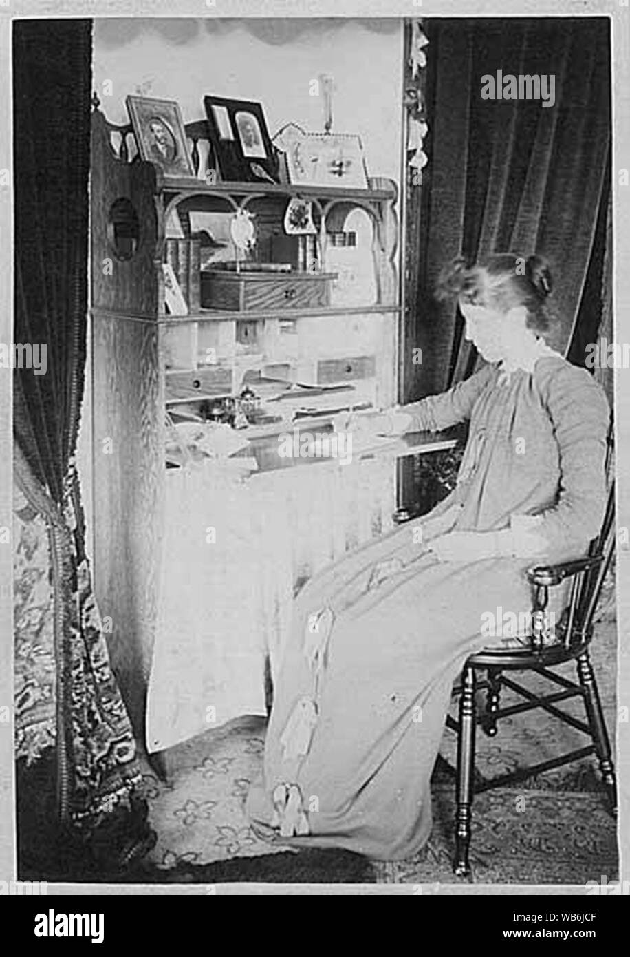 Edith Warner writing at a desk probably inside the Warner home in ...