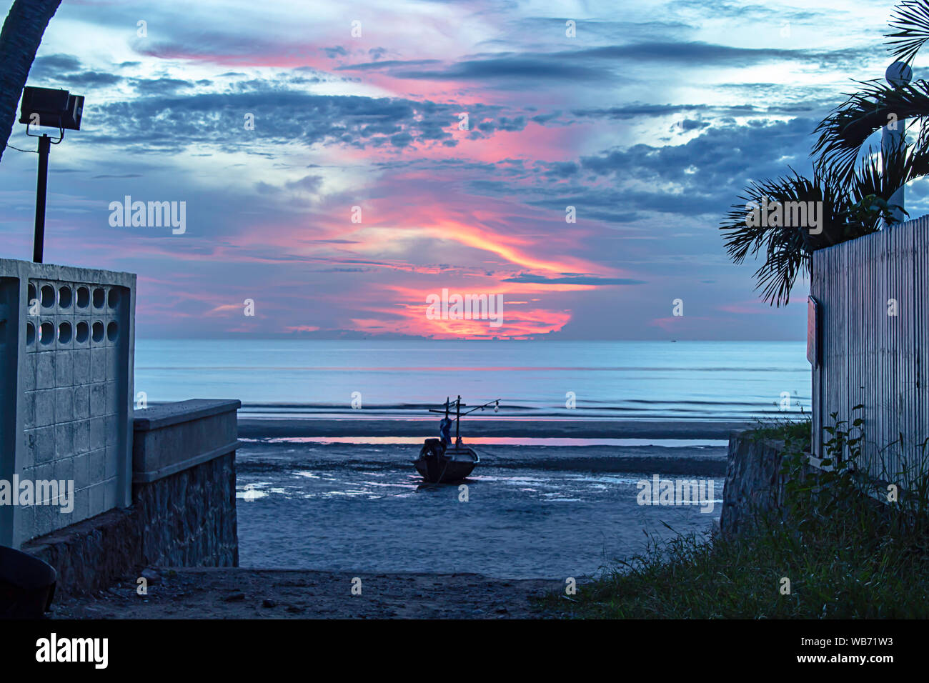 The morning sun light in the sea, and the boat on the beach Stock Photo ...