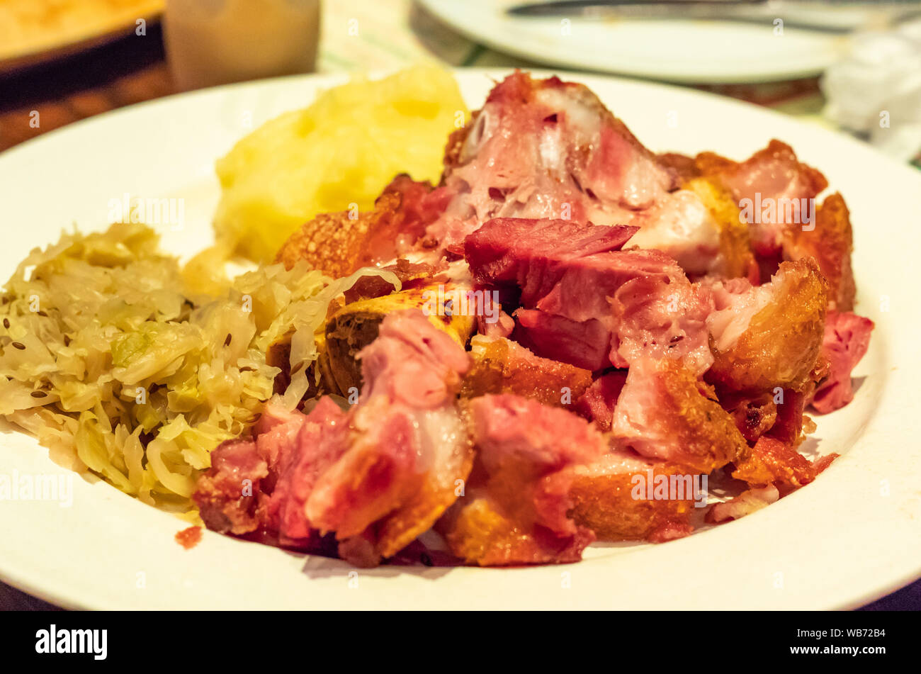 German pork fried with vegetables on a white plate Stock Photo - Alamy