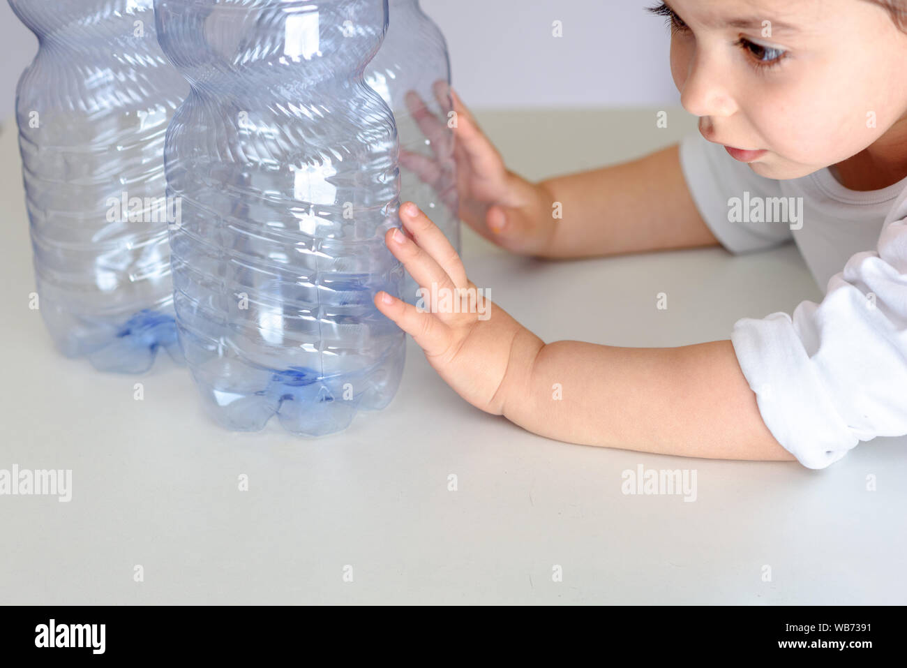 Child's hand push the plastic bottles. Conceptual image for anti ...